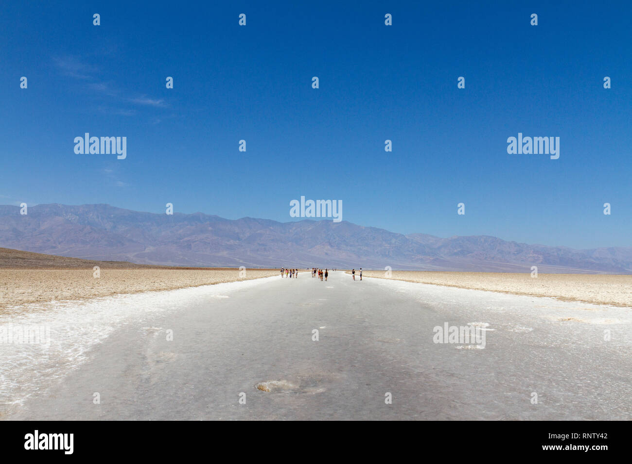 Visitors heading out onto the salt pan at Badwater Basin, Death Valley ...