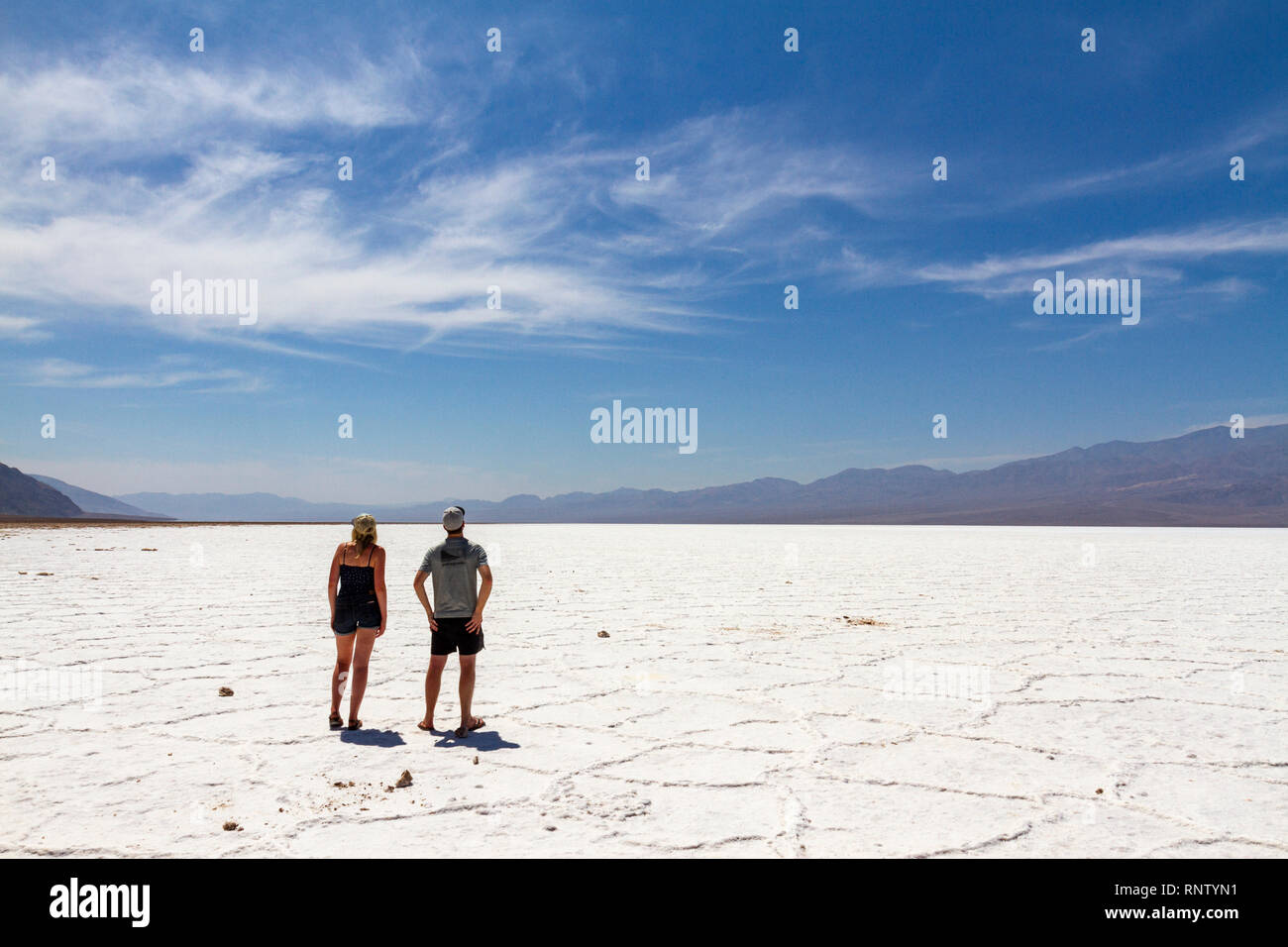 A pair of visitors look out on the salt pan, Badwater Basin, Death ...