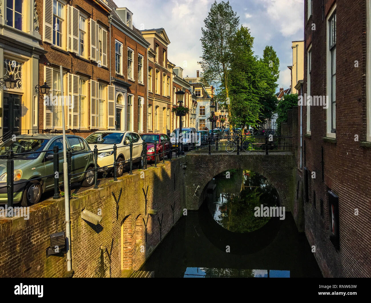 An amazing view of the old canal with bridges and a cozy street with ...