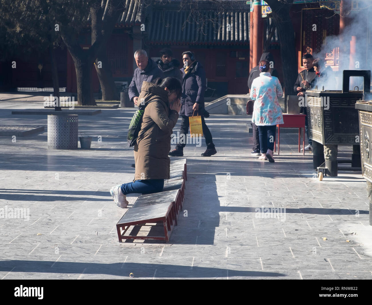BEIJING, CHINA - JANUARY 16, 2019: Unidentified woman praying in the ...