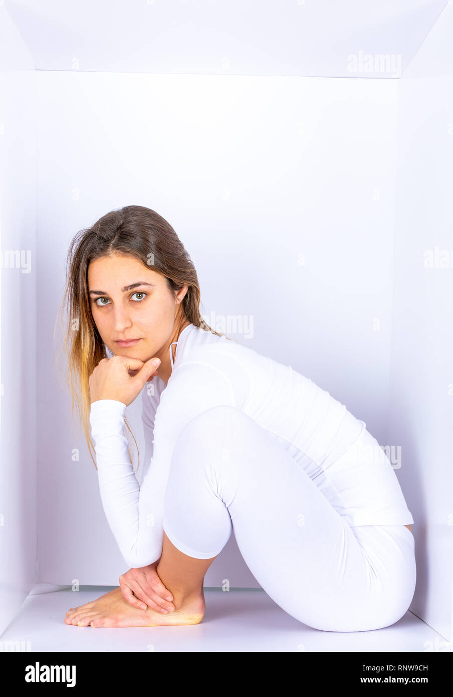 Woman wearing white posing in box Stock Photo - Alamy