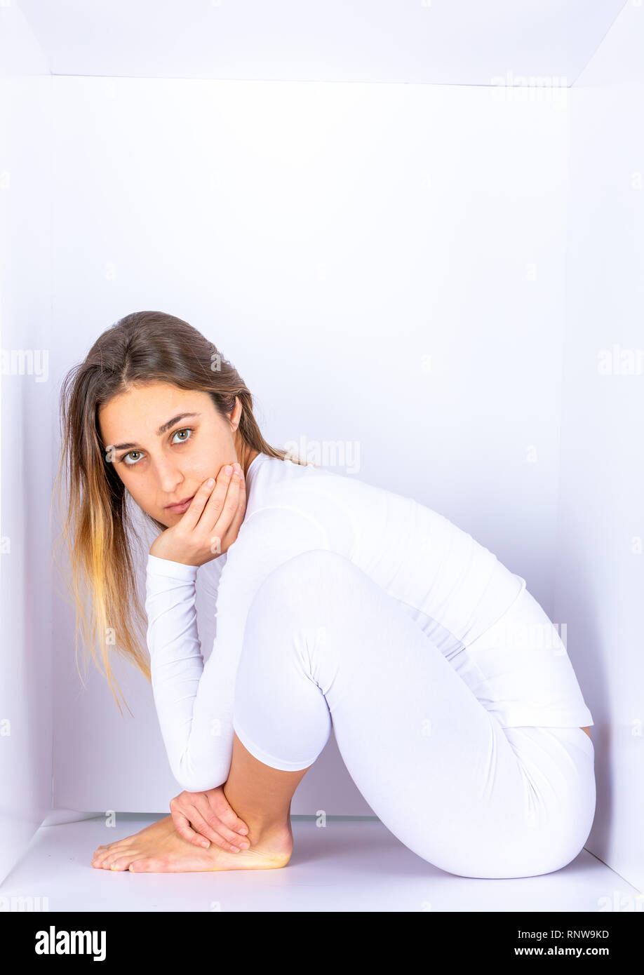 Woman wearing white posing in box Stock Photo - Alamy
