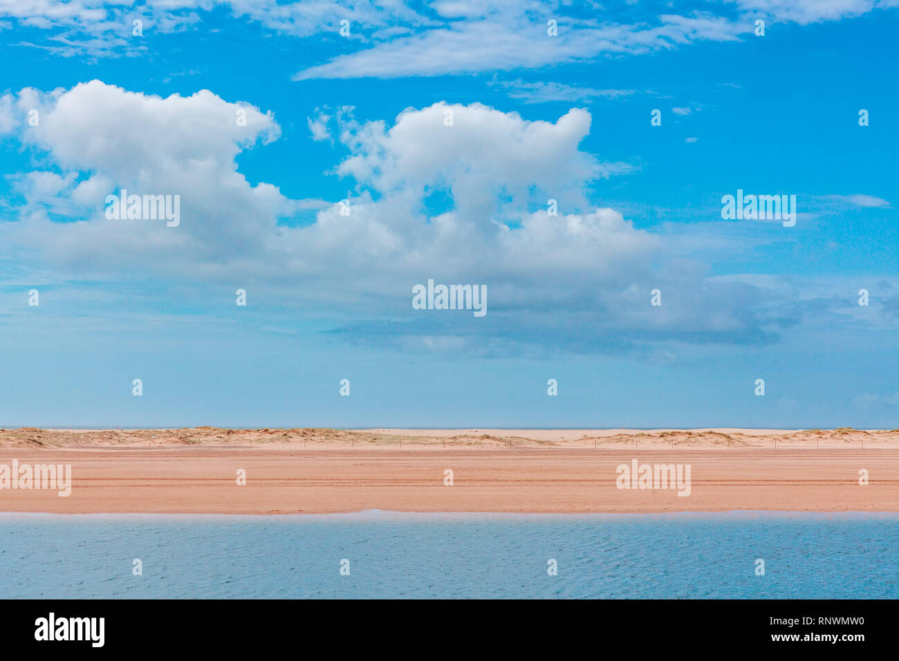 Minimalist landscape - stretch of sand between water and skies Stock ...