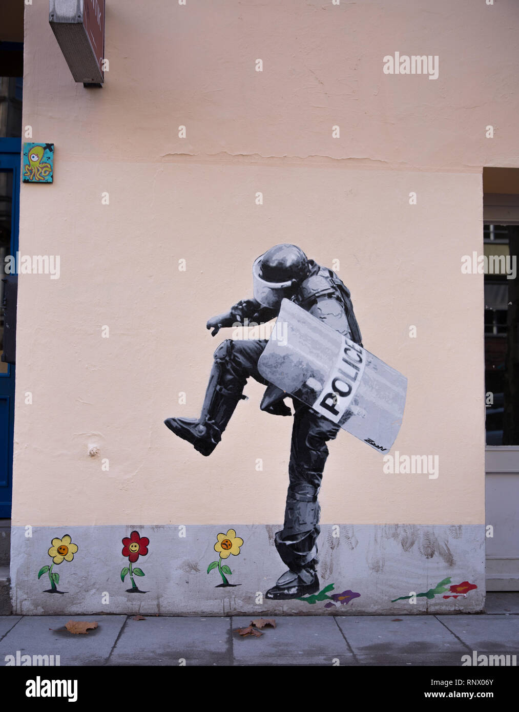 A post up and graffiti of a police officer stepping on a line of ...