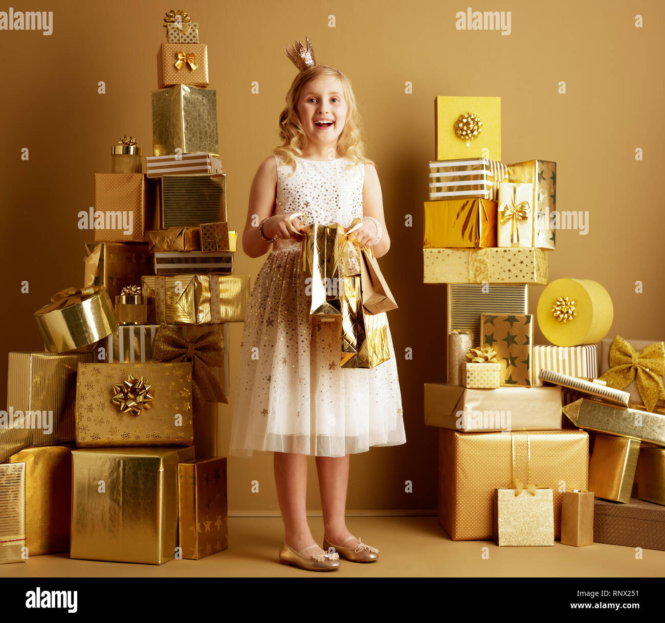 Full length portrait of surprised young little princess in beige fit ...