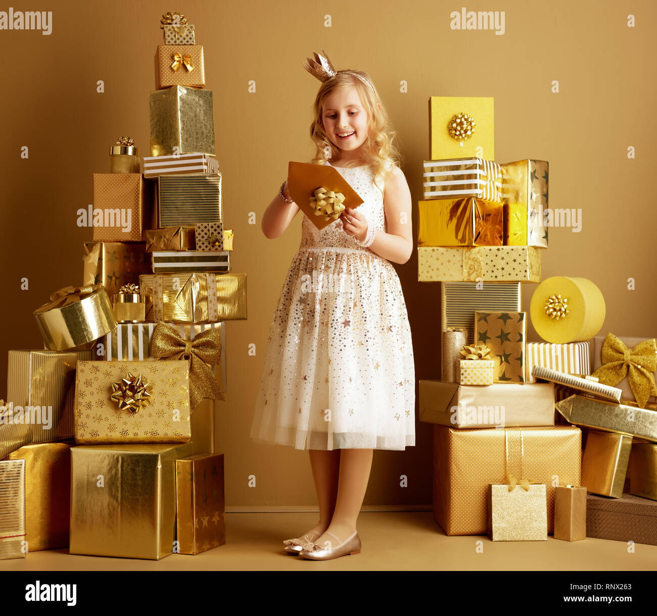 Full length portrait of surprised young little princess in beige fit ...