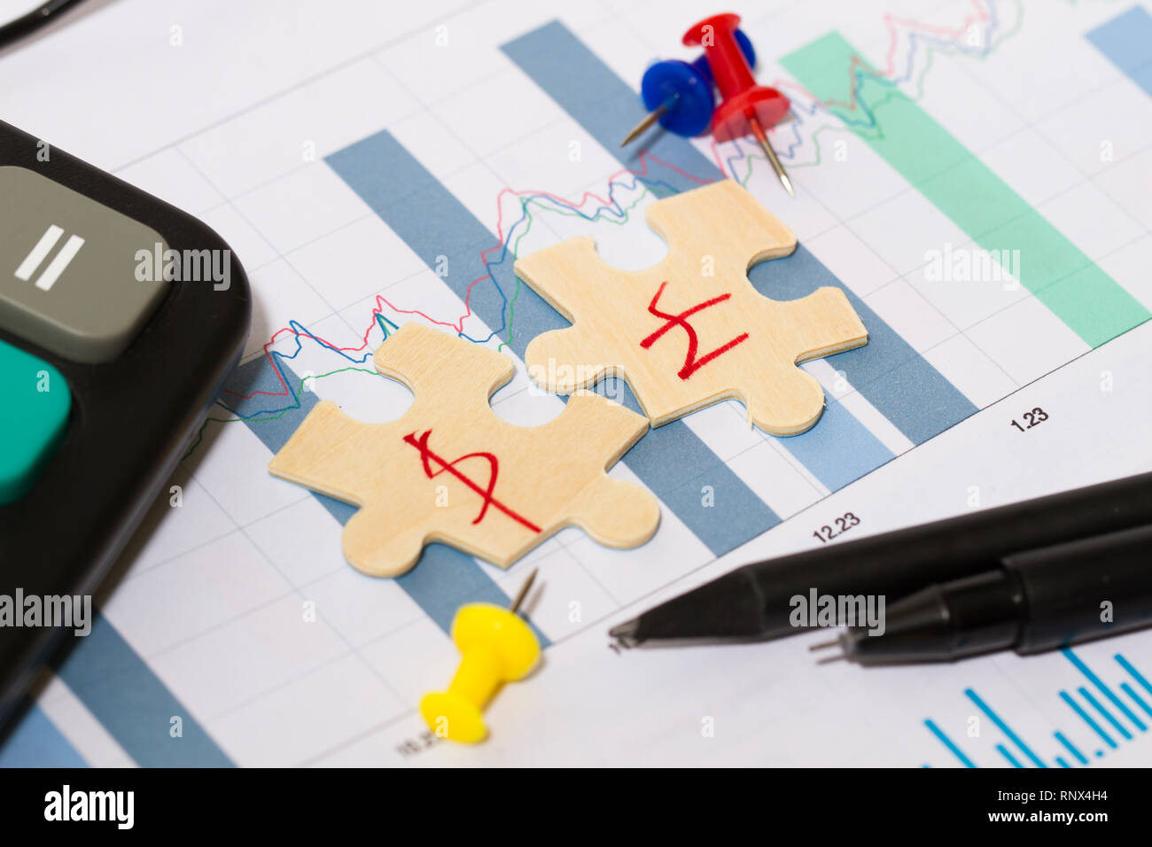 Puzzles and economic charts, teamwork, dollars and pounds Stock Photo ...