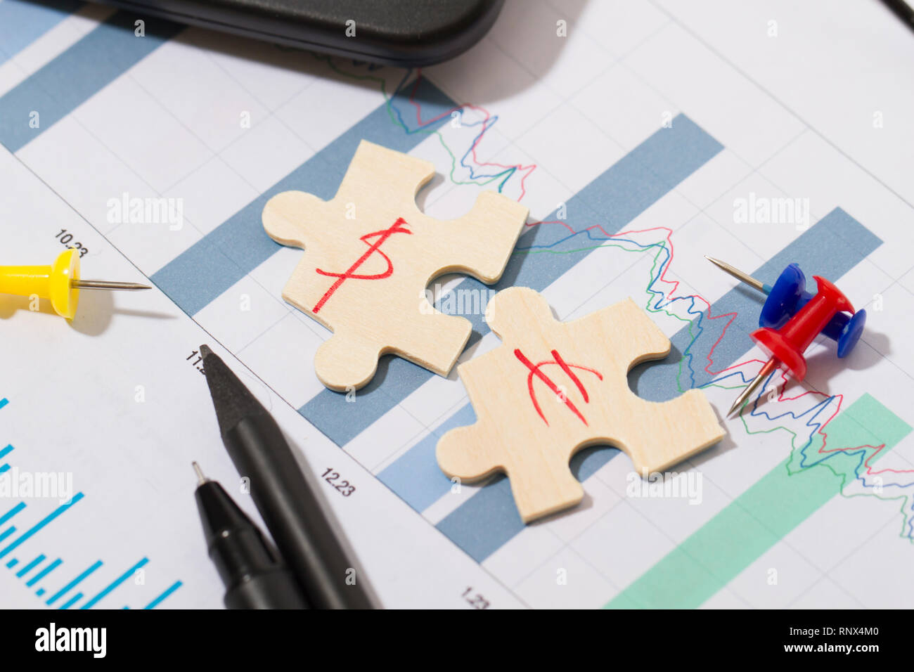 Puzzles and economic charts, teamwork, dollar and euro Stock Photo - Alamy