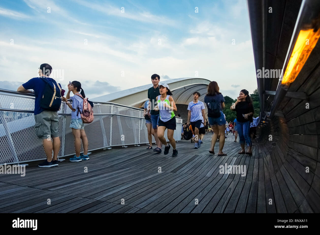 Jogger in tourist crowds on Henderson Waves Bridge, Mount Faber Park ...