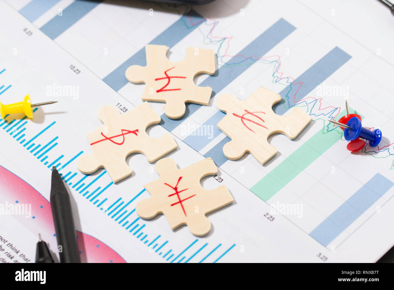 Puzzles with economic charts, teamwork, currency symbols Stock Photo ...