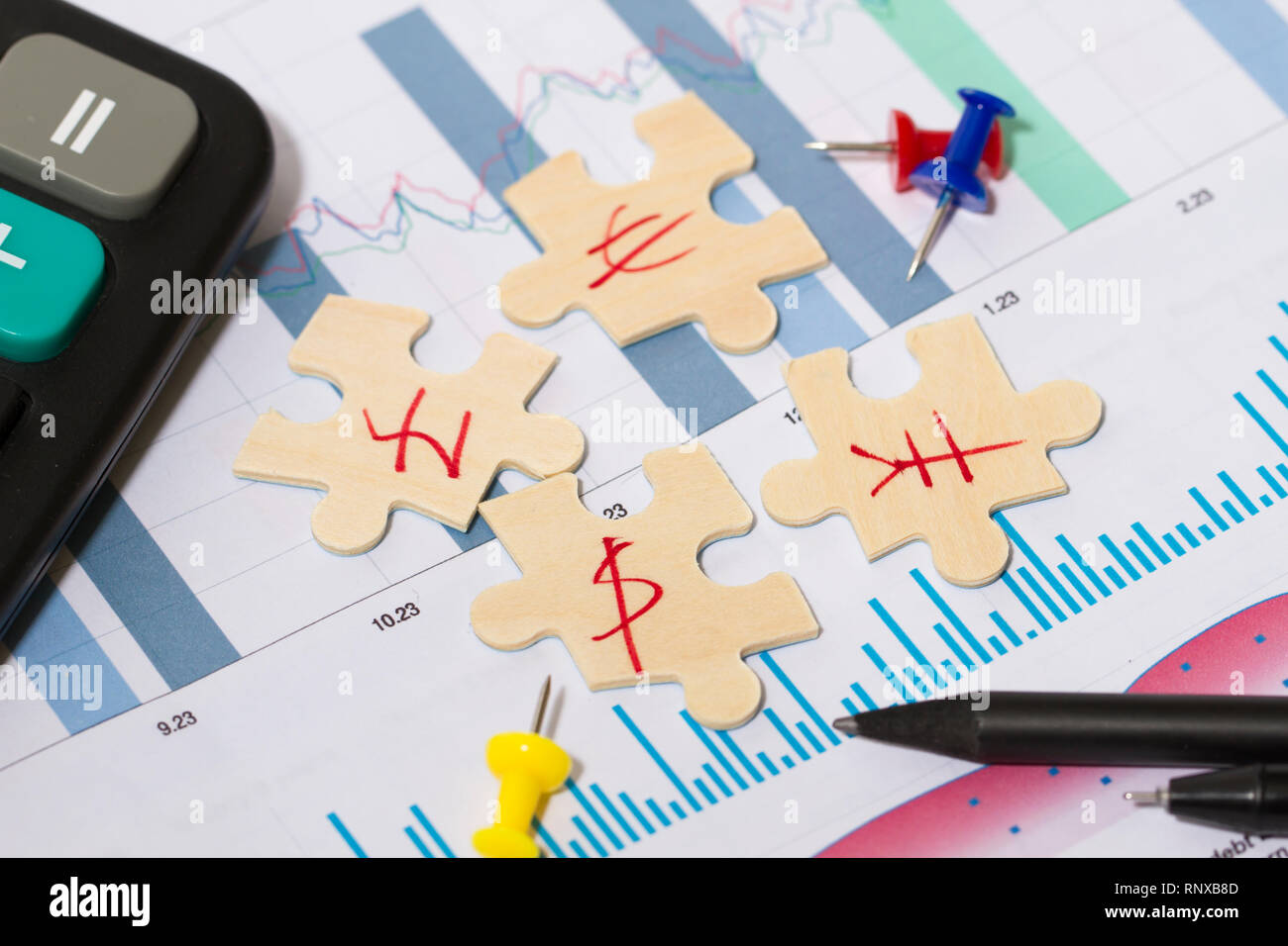 Puzzles with economic charts, teamwork, currency symbols Stock Photo ...