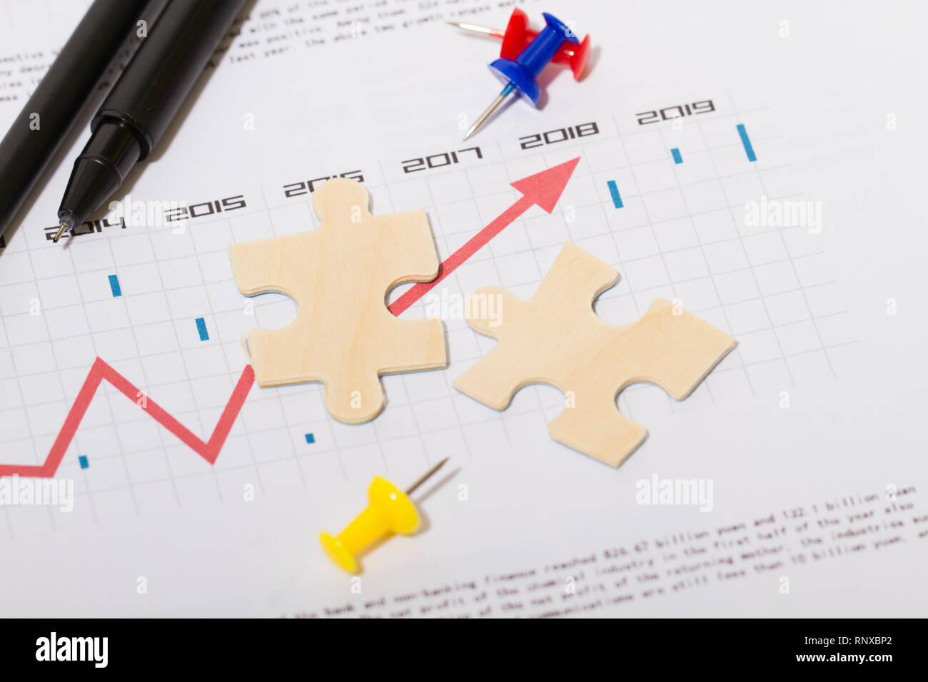 Puzzles and economic charts, teamwork, career success Stock Photo - Alamy