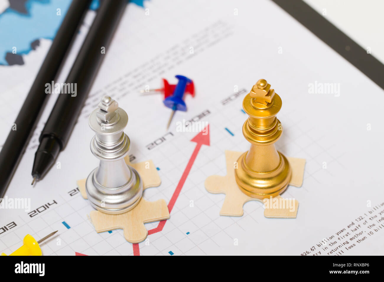 Puzzles and economic charts, teamwork, career success Stock Photo - Alamy