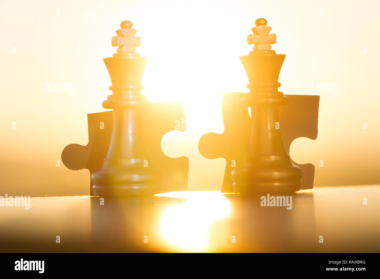 Chess pieces and puzzles, teamwork Stock Photo - Alamy