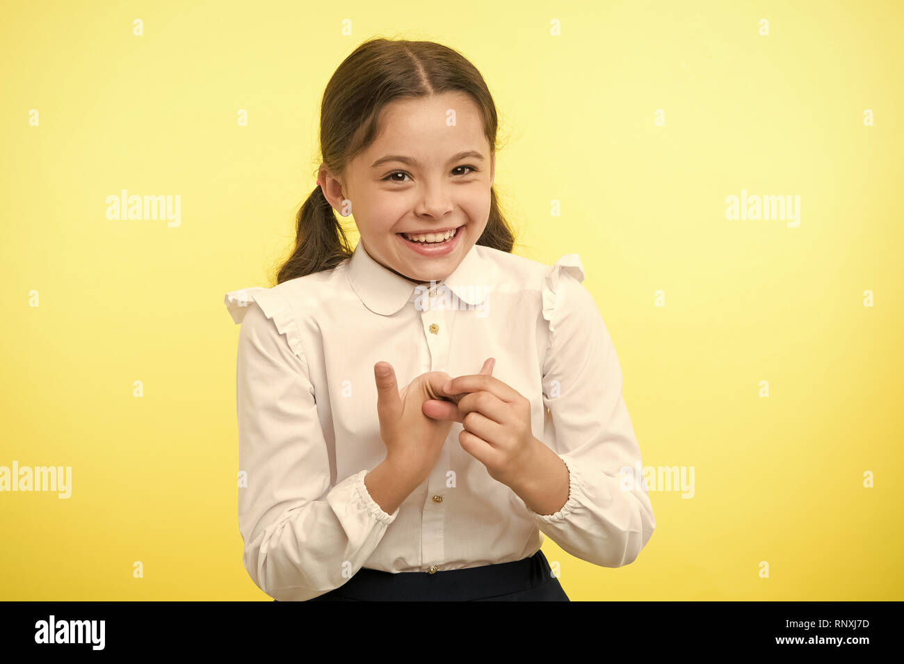 happy child. happy child in school uniform. happy child on yellow ...