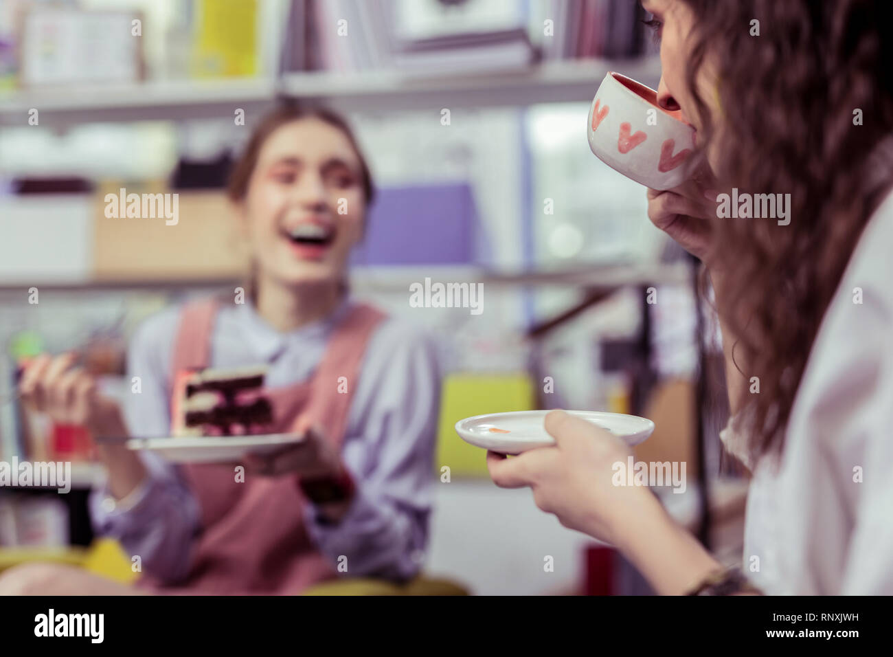 Girl laughing drinking tea hi-res stock photography and images - Alamy