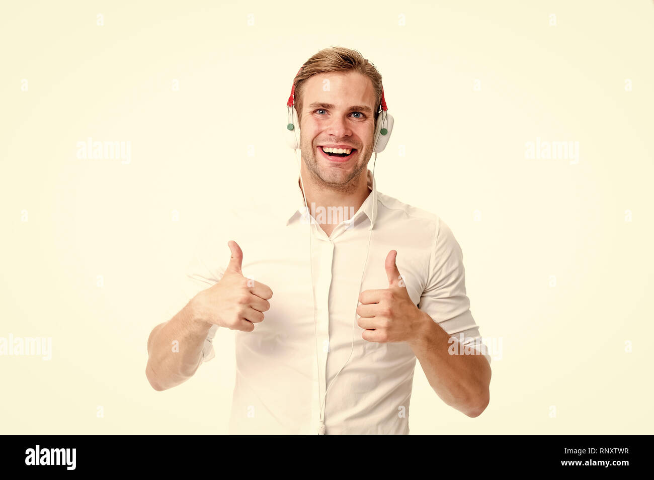 Best song ever. Man listening favourite song in headphones shows thumbs ...