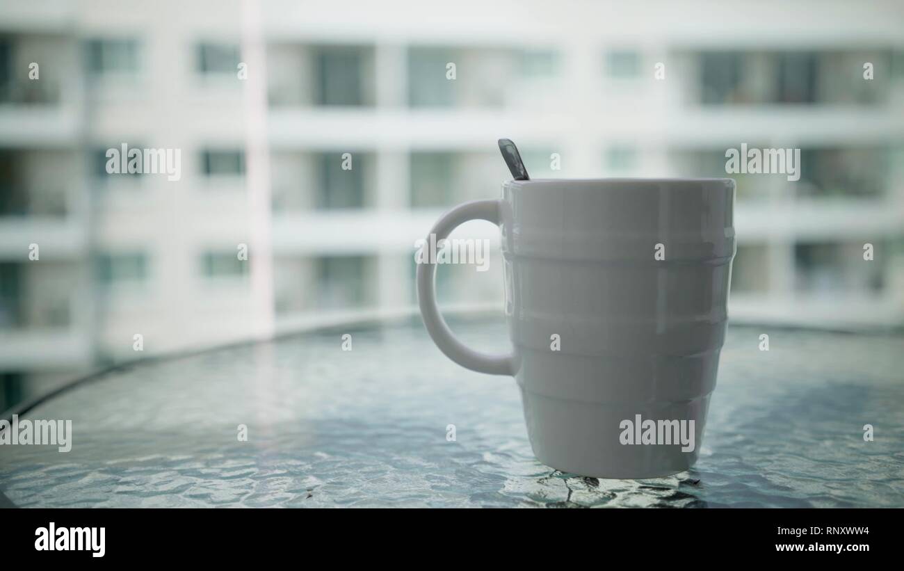 White mug on table and modern room background Stock Photo - Alamy