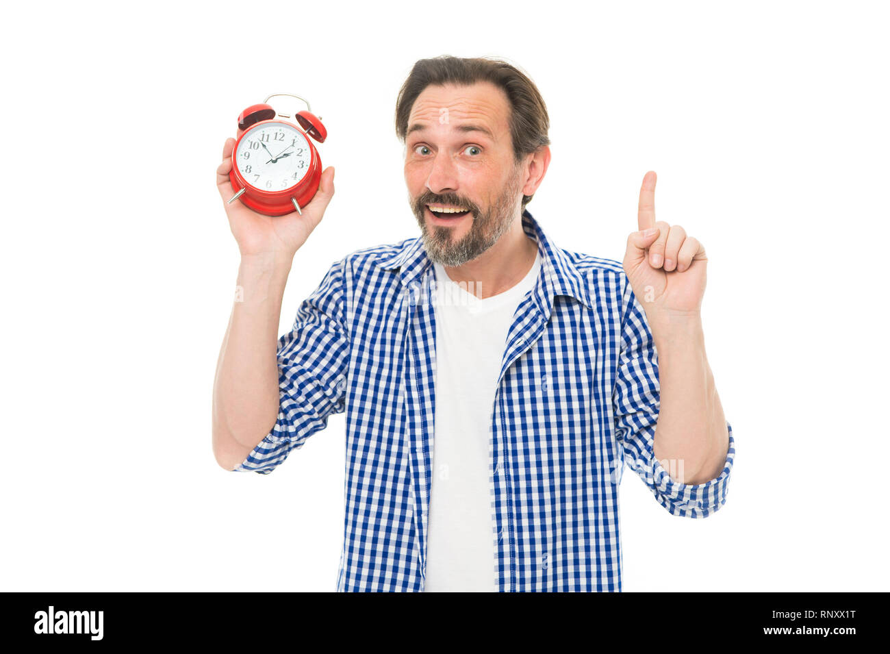 Keeping track of time. Mature timekeeper with analog clock pointing ...