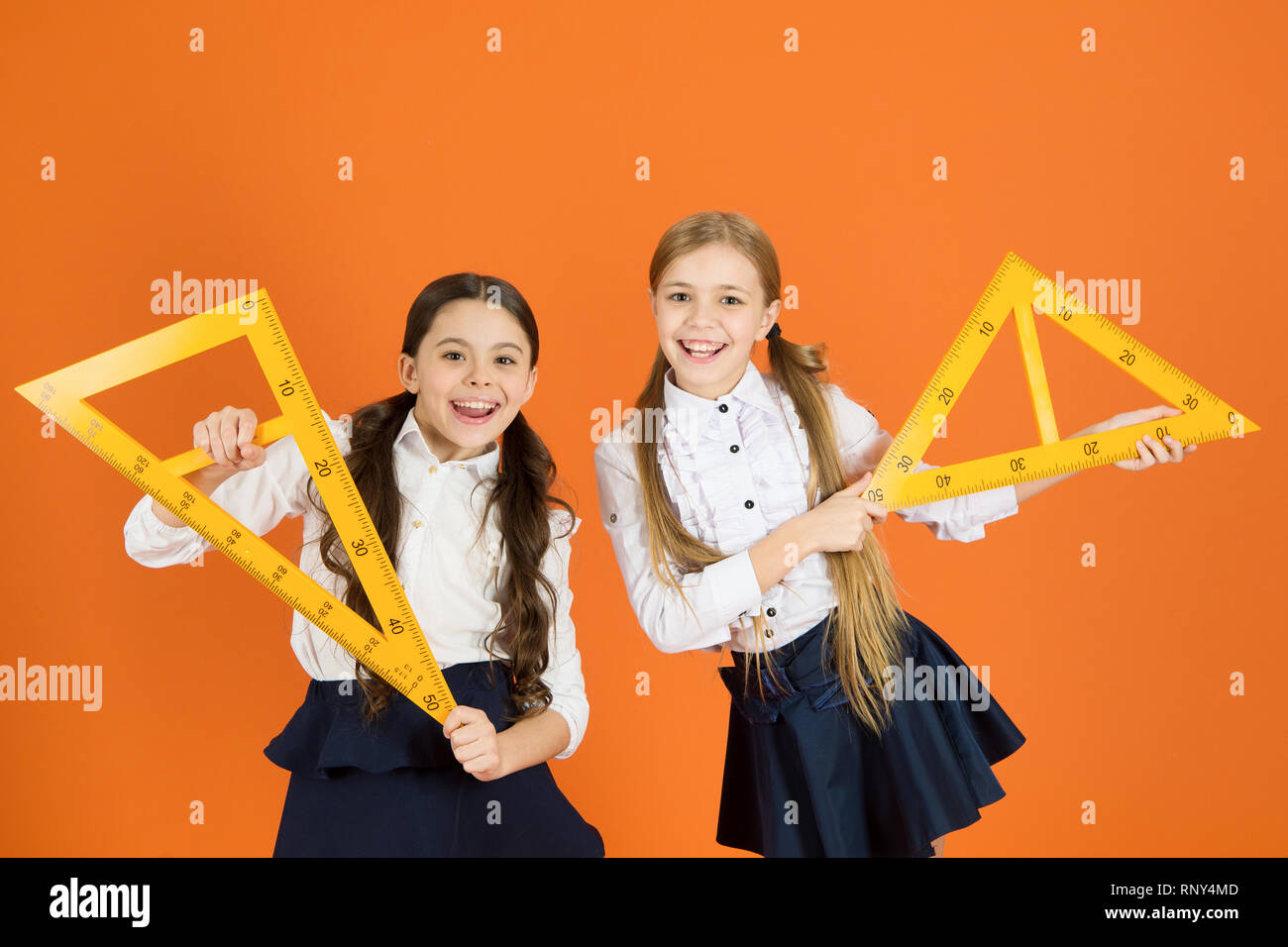 Kids school uniform on orange background. Pupil cute girls with big ...