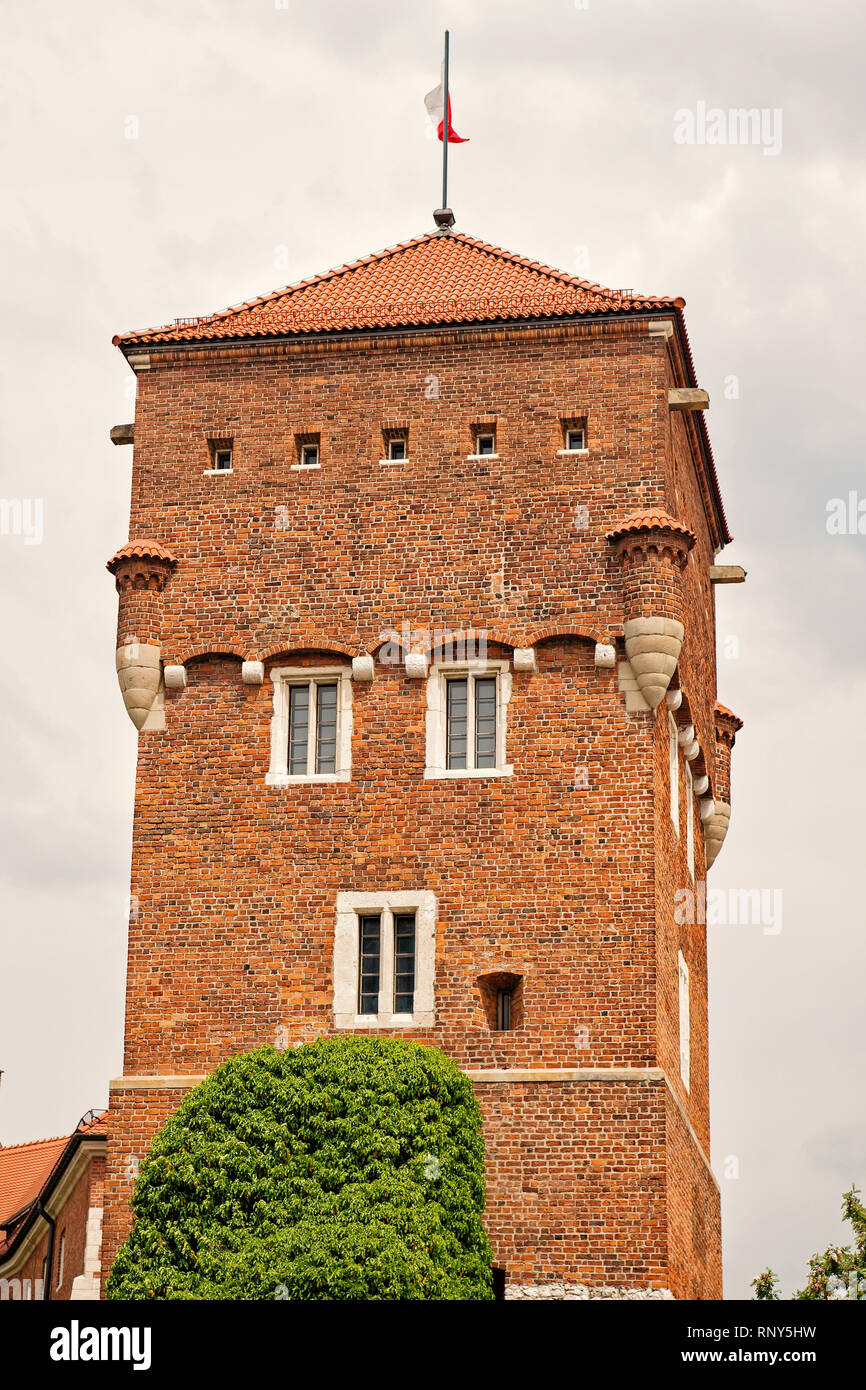 Tower with national flag on red roof in krakow, poland on grey sky ...