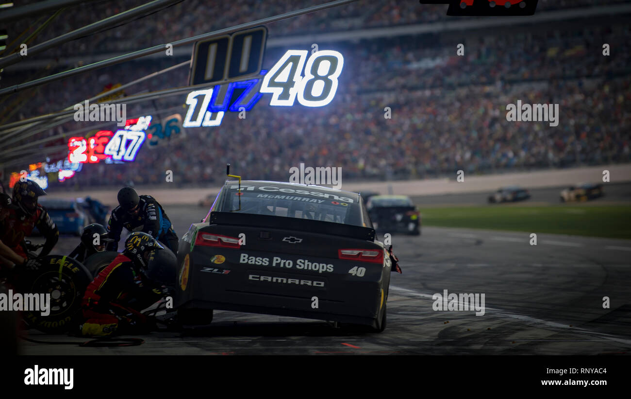Jamie McMurray, and his pit crew perform maintenance on the #40 car ...