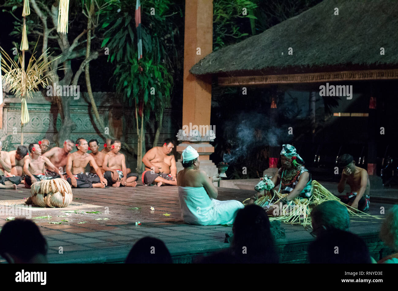 Kecak and Barong Fire Dance. Two guys prepare for fire dance show near ...
