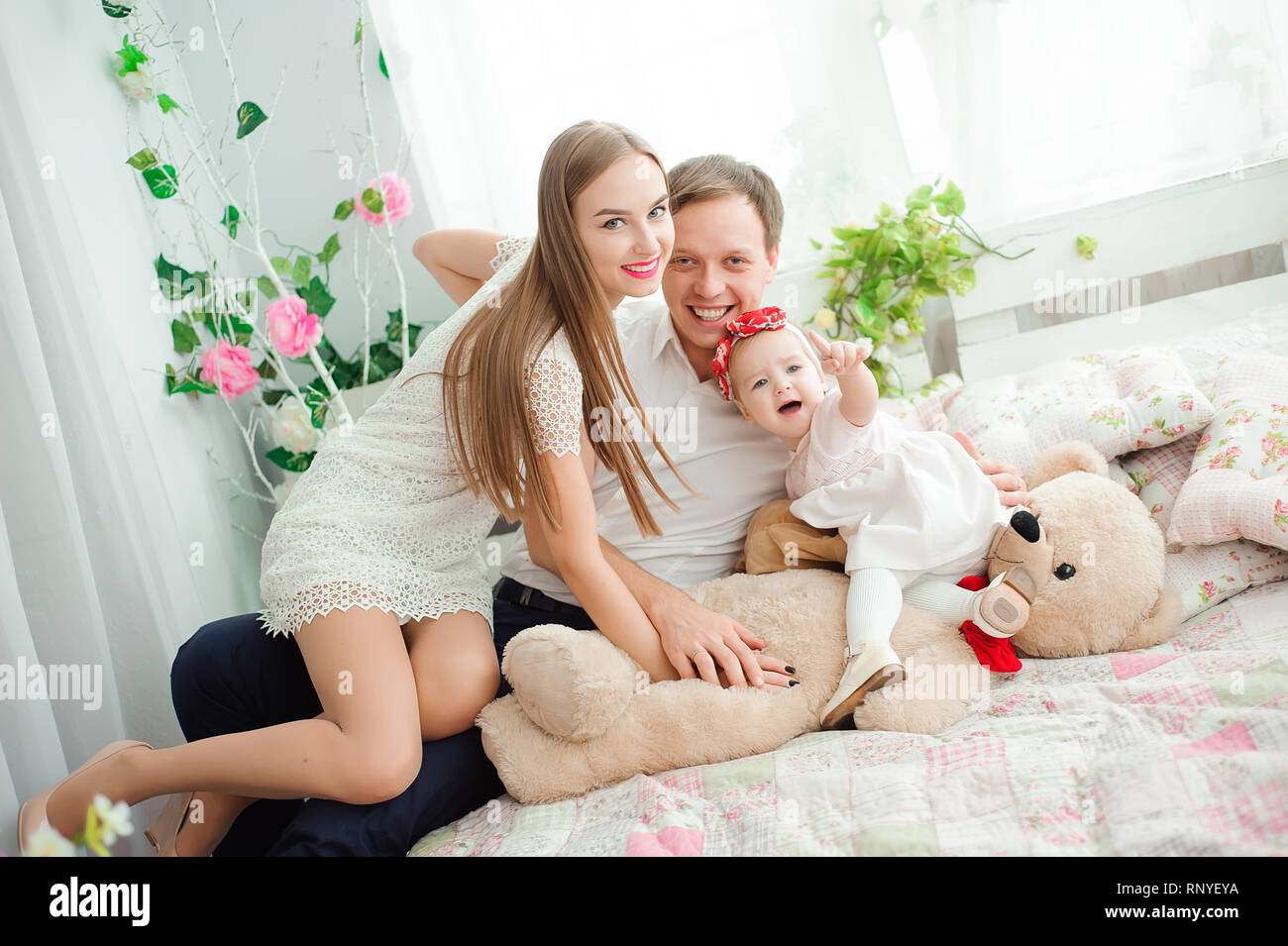 Lovely family smiling and laughing, posing at camera Stock Photo - Alamy