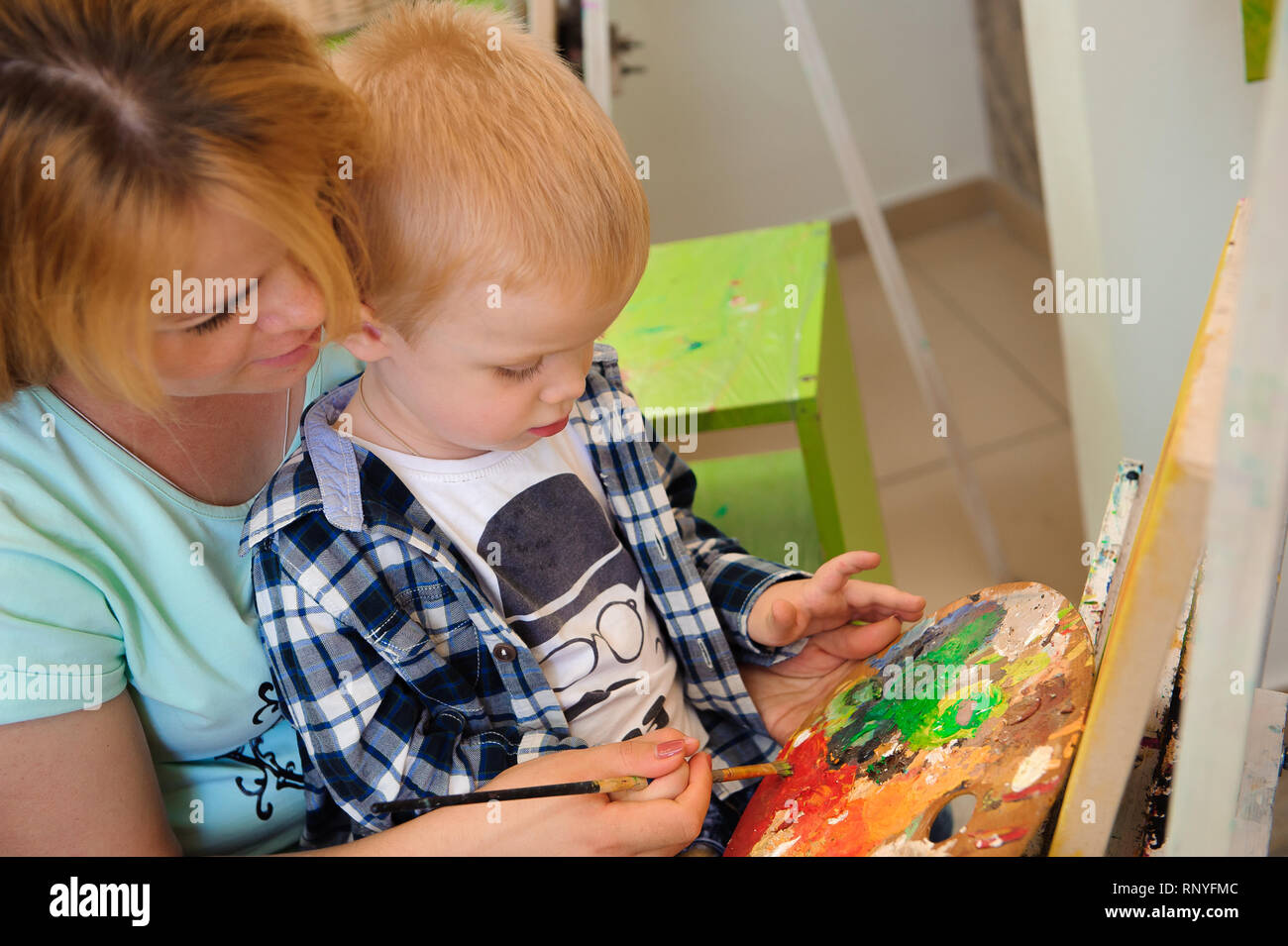 Mother and child draw a picture paints, art lesson Stock Photo - Alamy