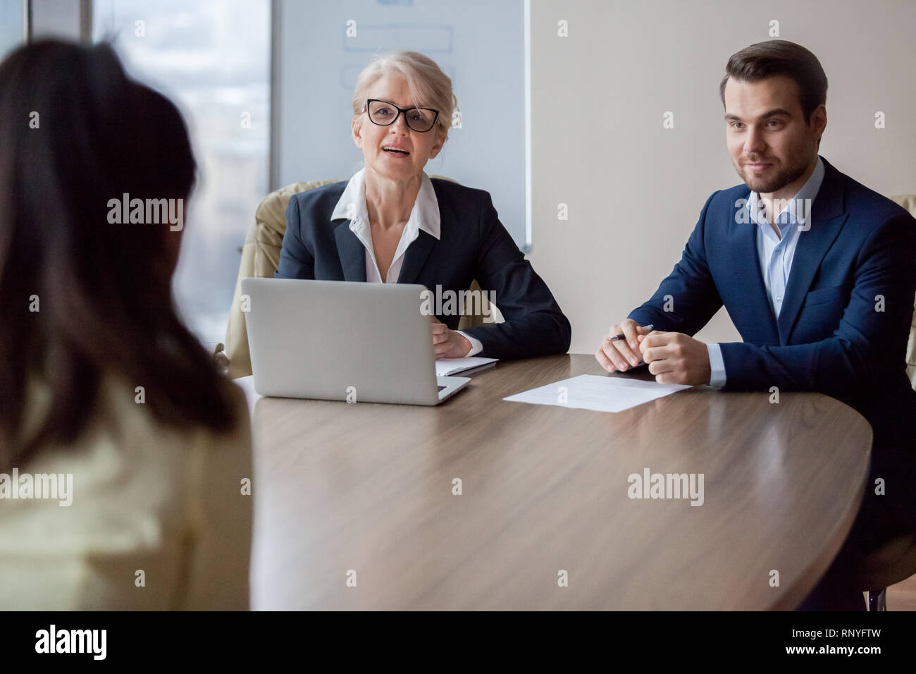 Interested hr managers focused on listening applicant at job interview ...
