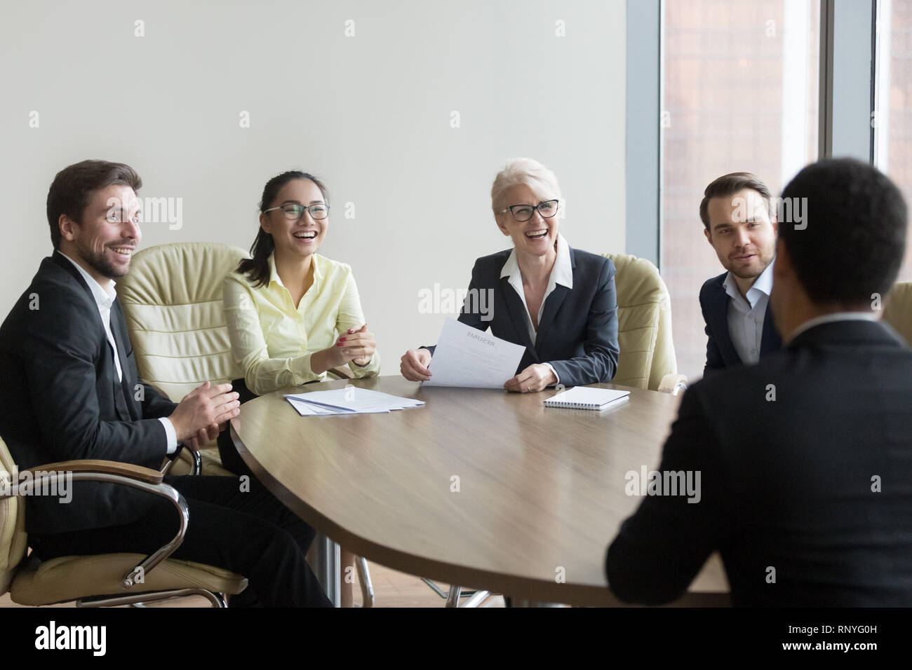 Hr managers laugh at joke of applicant at job interview Stock Photo - Alamy