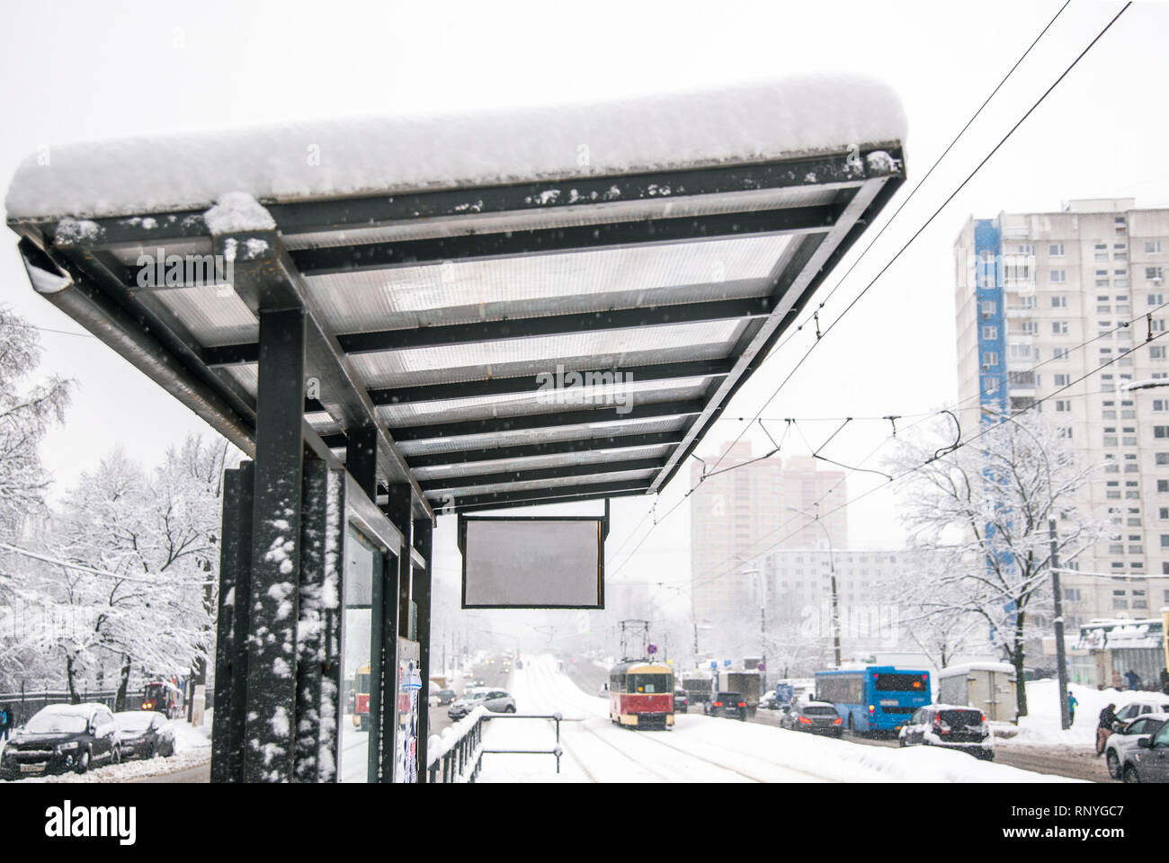 Winter city public transport stop perspective view Stock Photo - Alamy