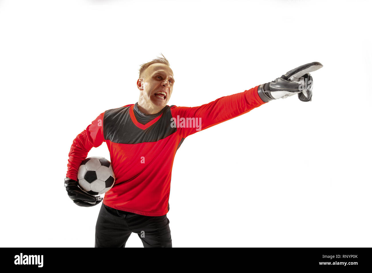 One male soccer player goalkeeper pointing away and screaming isolated ...