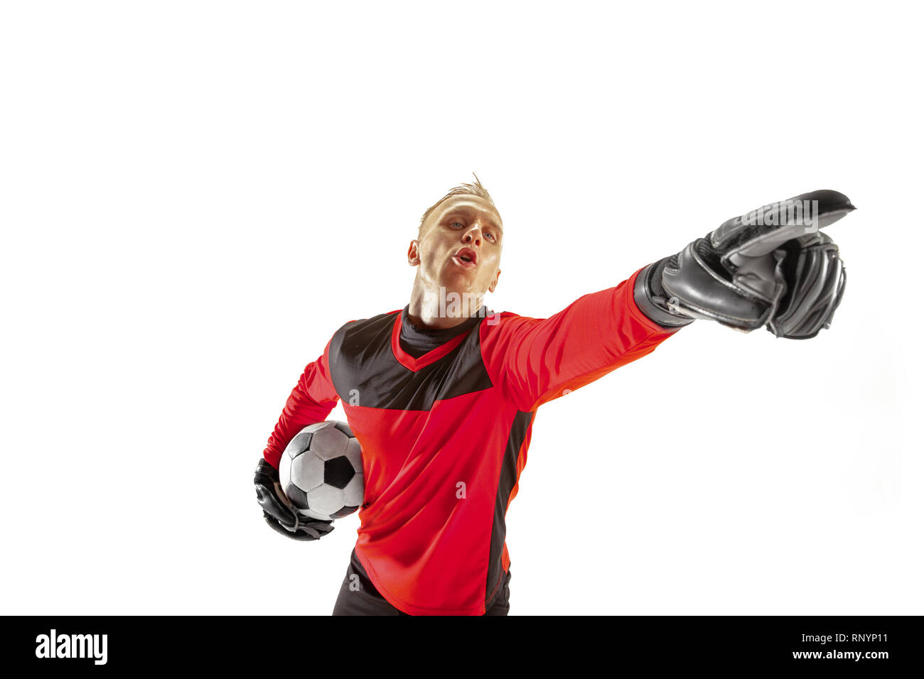 One male soccer player goalkeeper pointing away and screaming isolated ...