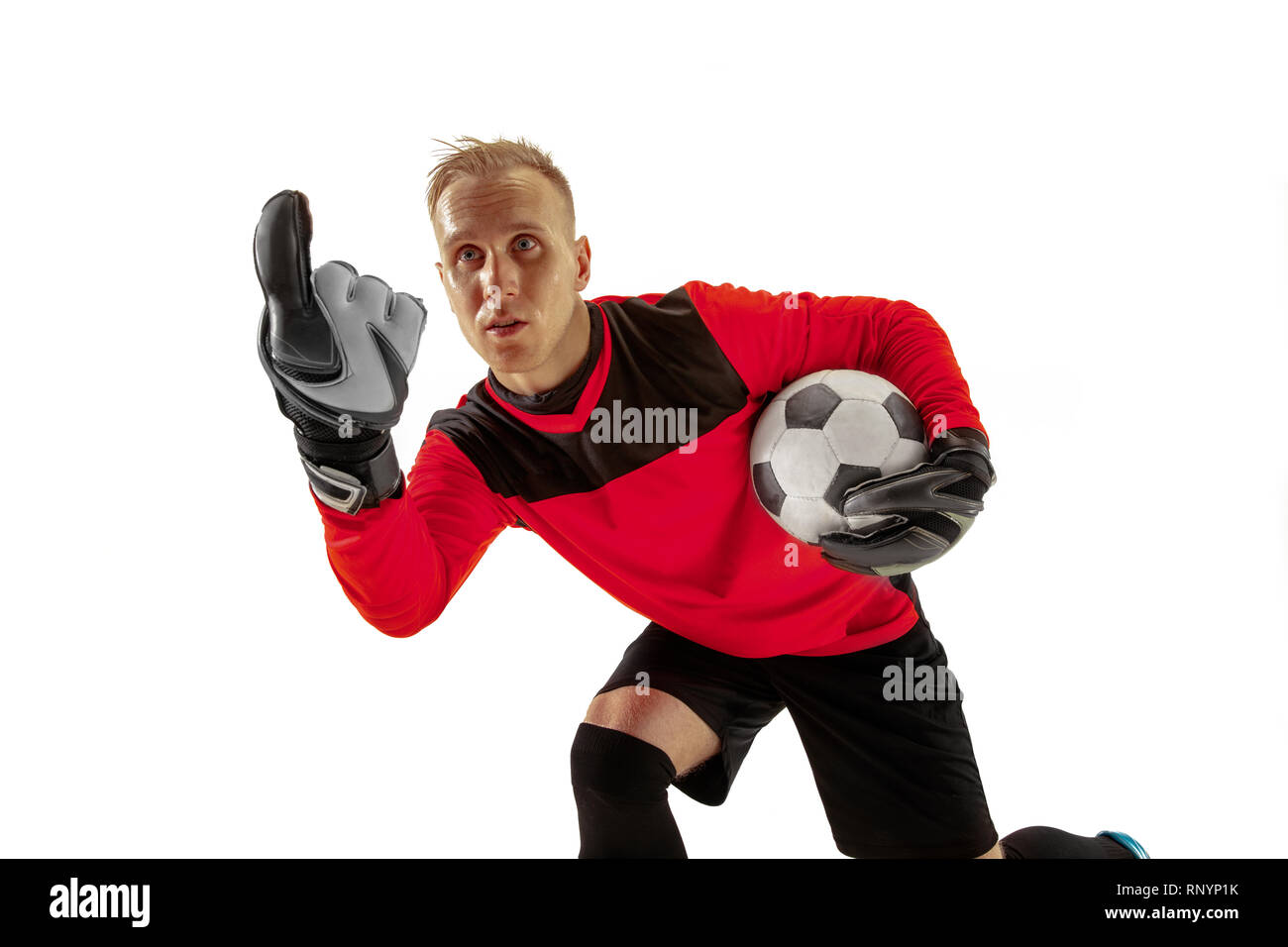 One male soccer player goalkeeper pointing away and screaming isolated ...