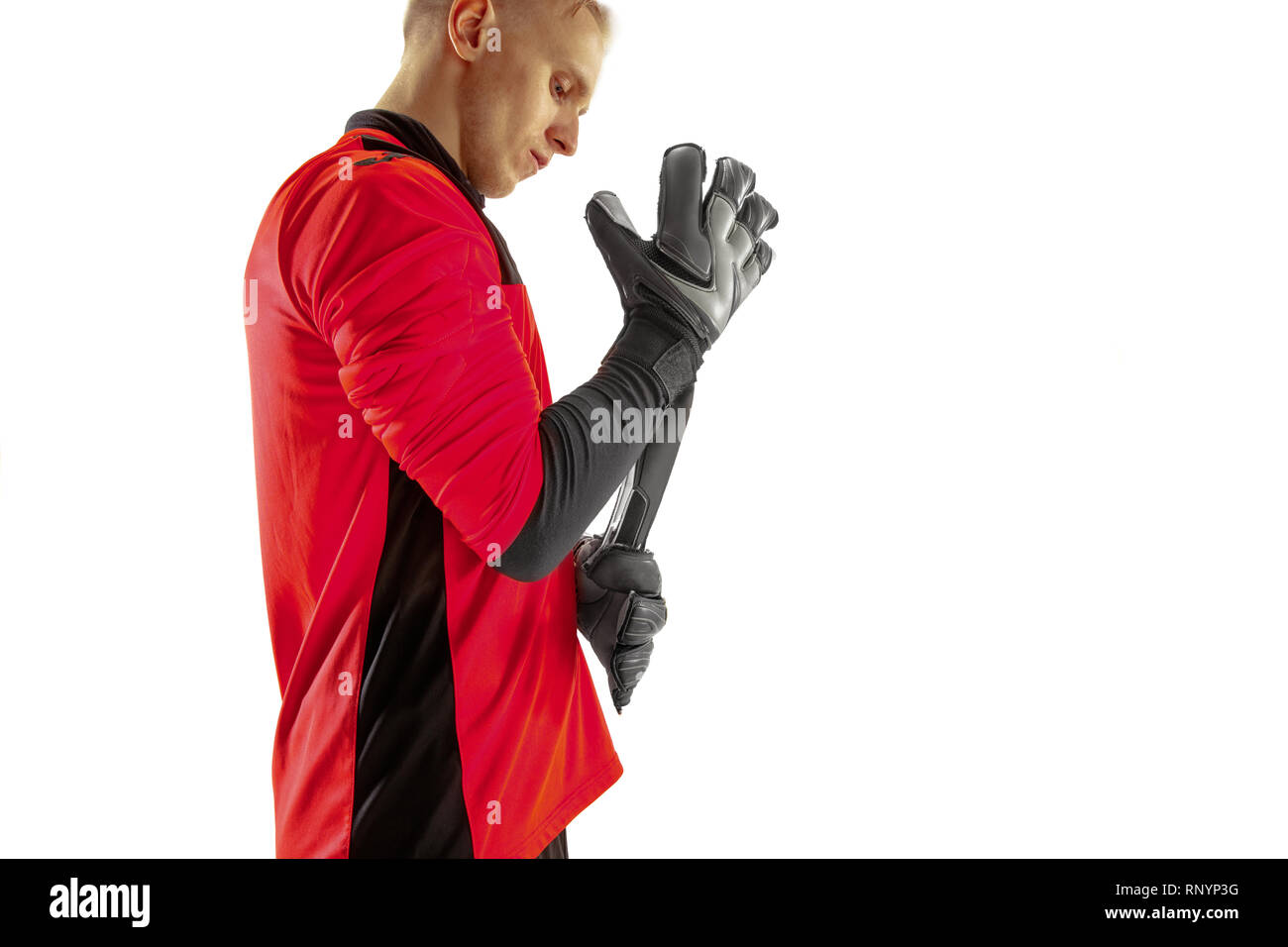 One male soccer player goalkeeper standing at studio. Silhouette ...