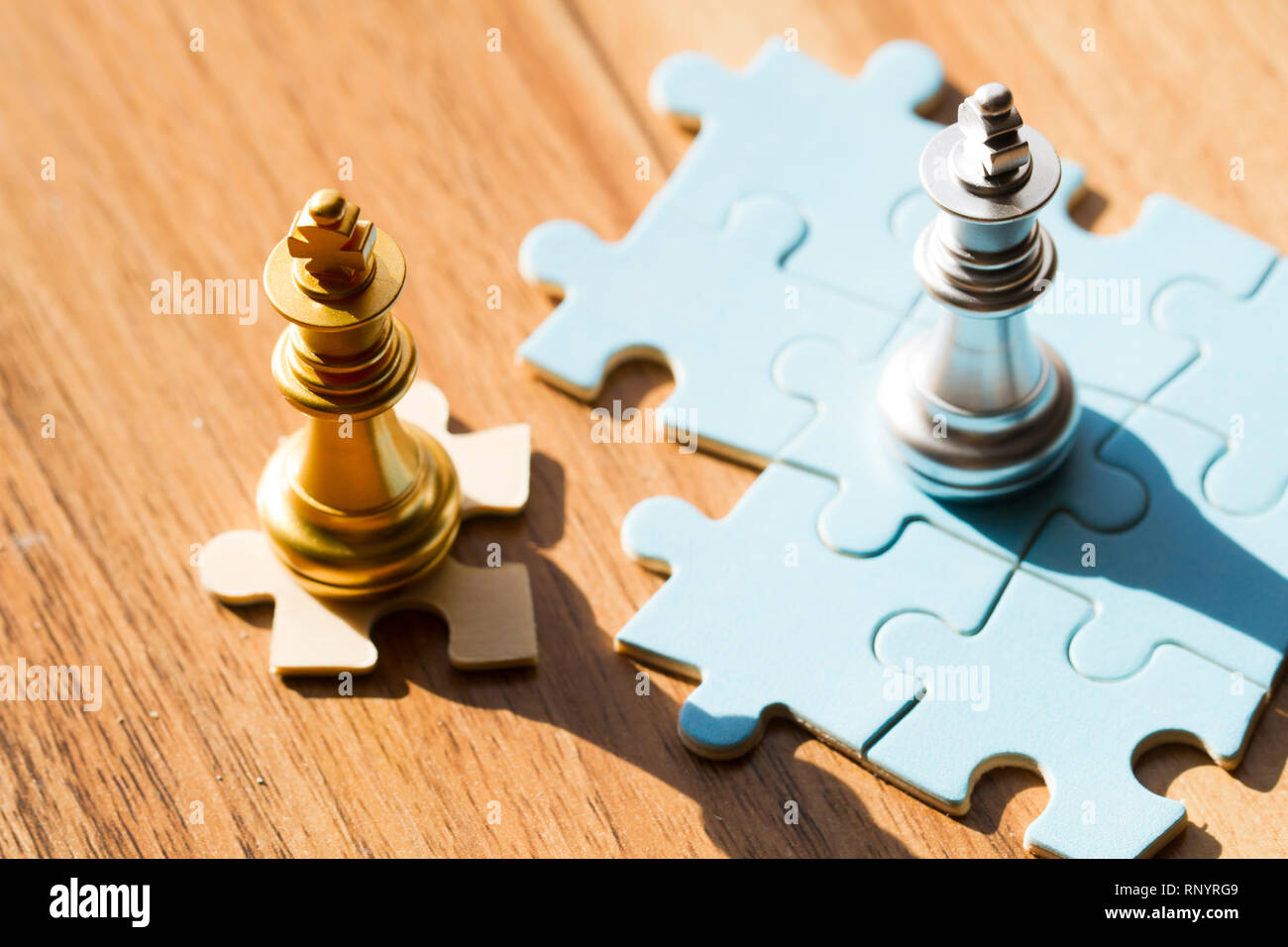Chess pieces and puzzles, teamwork Stock Photo - Alamy