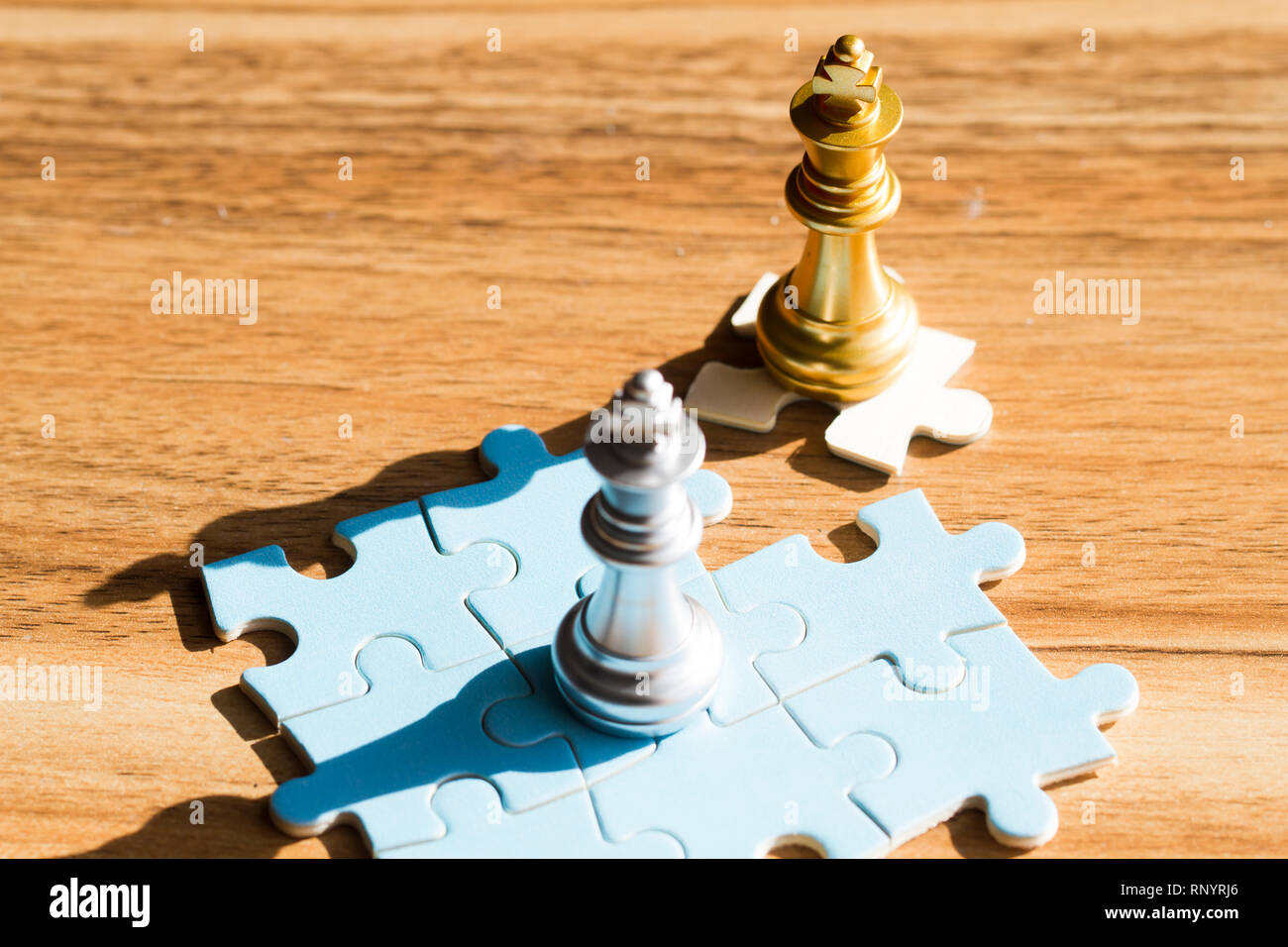 Chess pieces and puzzles, teamwork Stock Photo - Alamy