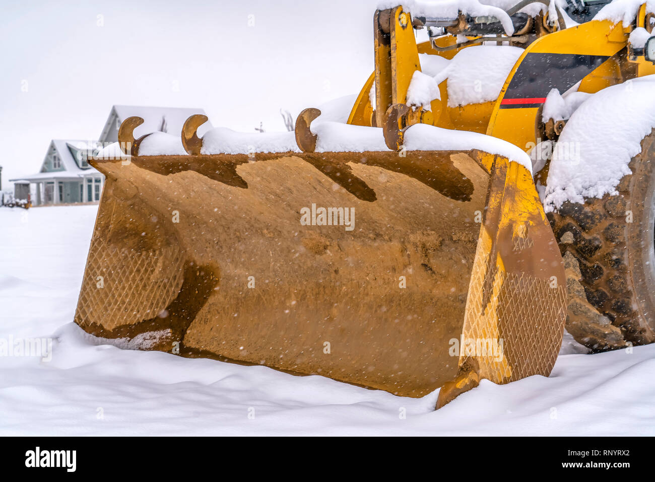 Metal bucket of a loader on snowy ground in winter Stock Photo - Alamy