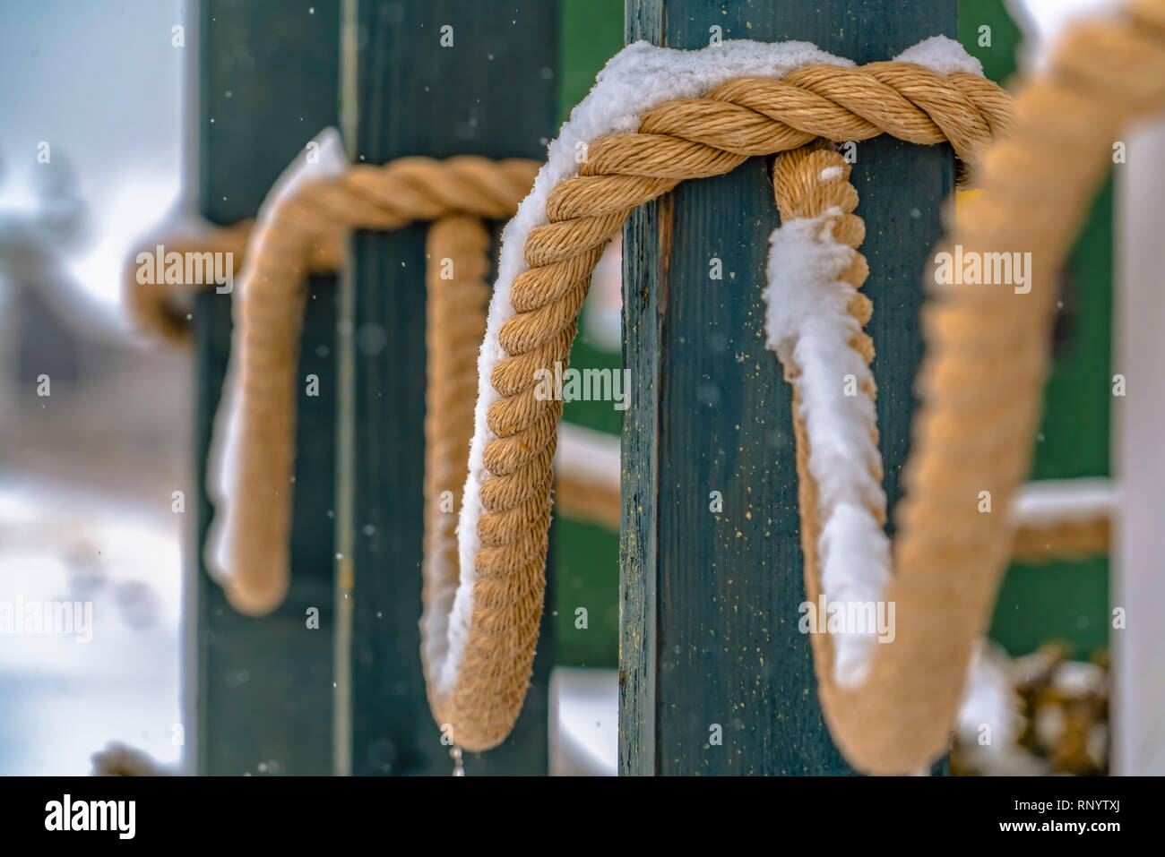 Snow on the rope of a fence in Daybreak Utah Stock Photo - Alamy