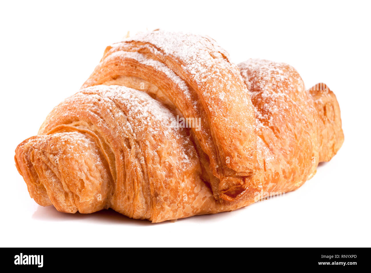 one croissant sprinkled with powdered sugar isolated on white ...