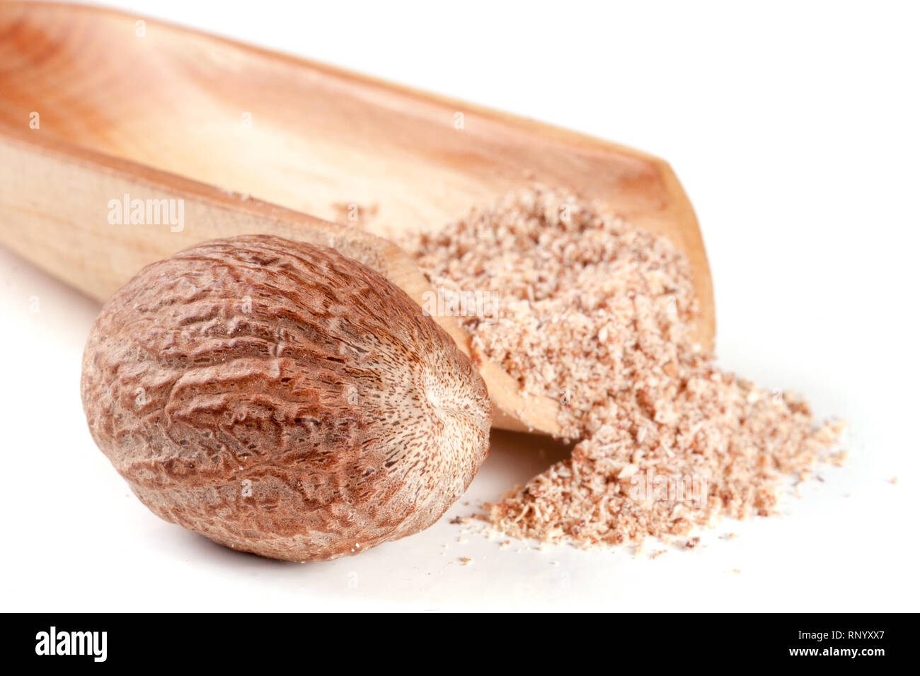 nutmeg with powder in a scoop isolated on white background Stock Photo ...