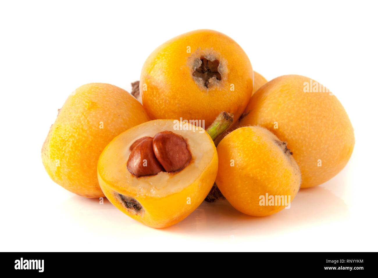 Ripe loquat or Eriobotrya japonica with leaf isolated on white ...