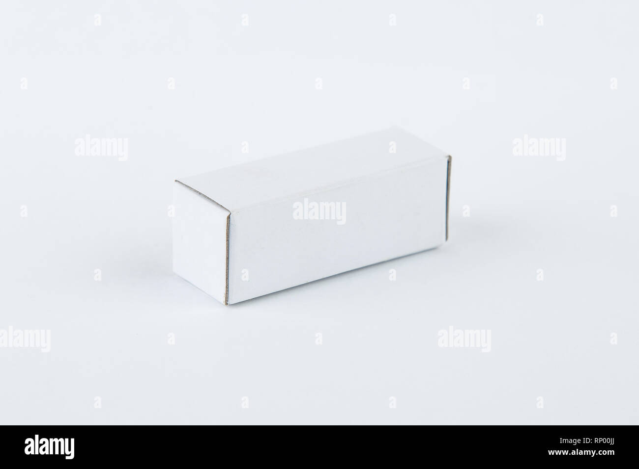 Close up of a small white cardboard box , isolated on white background ...
