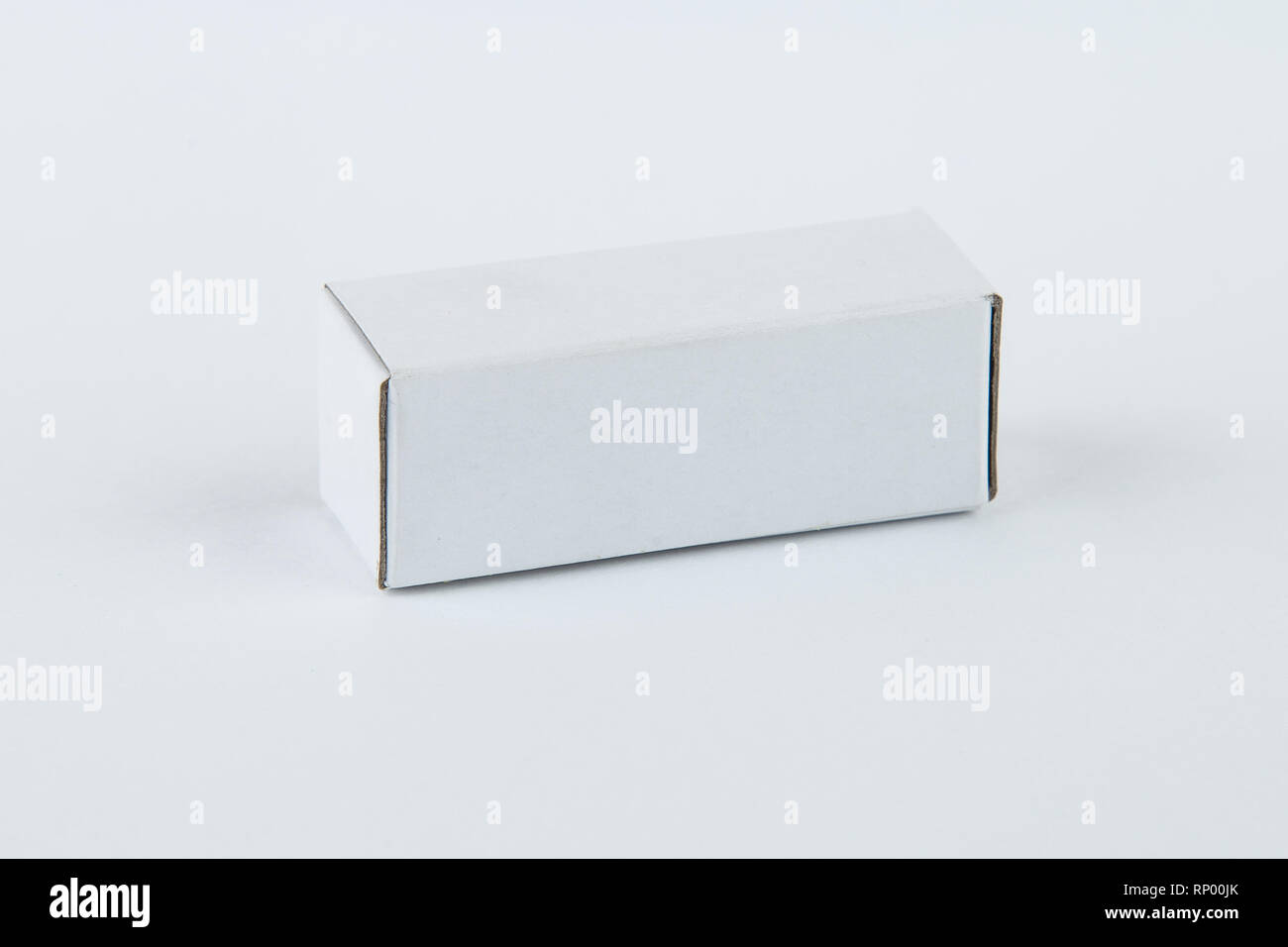 Close up of a small white cardboard box , isolated on white background ...