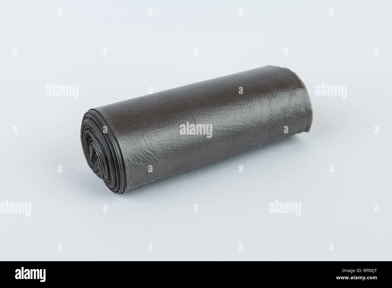 Black plastic polyethylene garbage bags roll isolated over the white ...