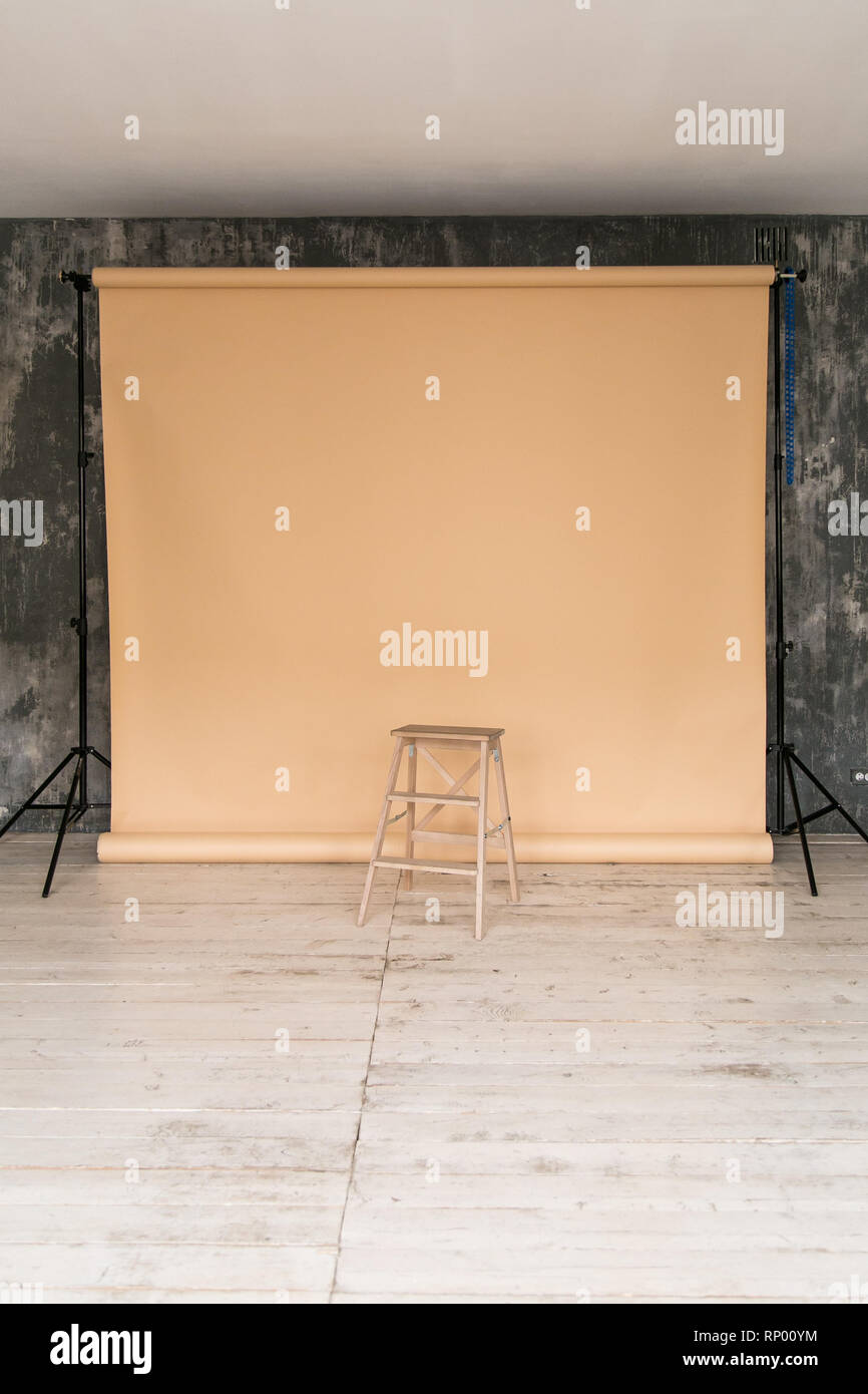The working space of the photo studio with a beige paper background and ...