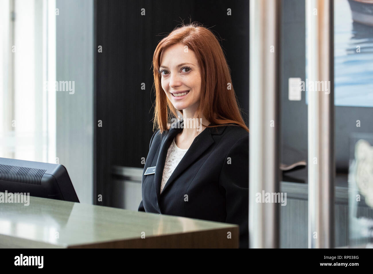 Female receptionist standing in hotel Stock Photo - Alamy