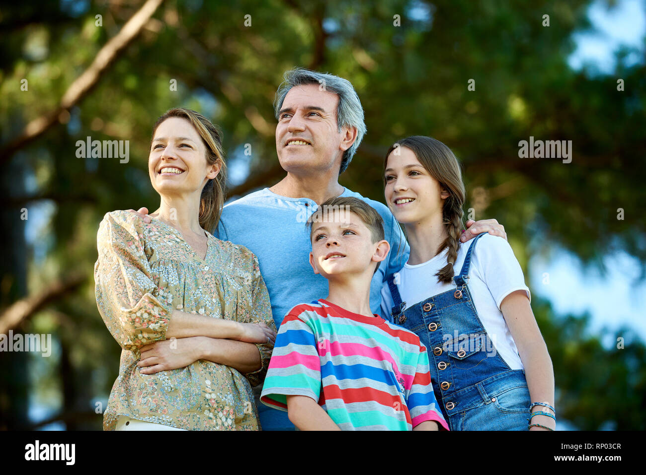 Family standing together in forest Stock Photo - Alamy