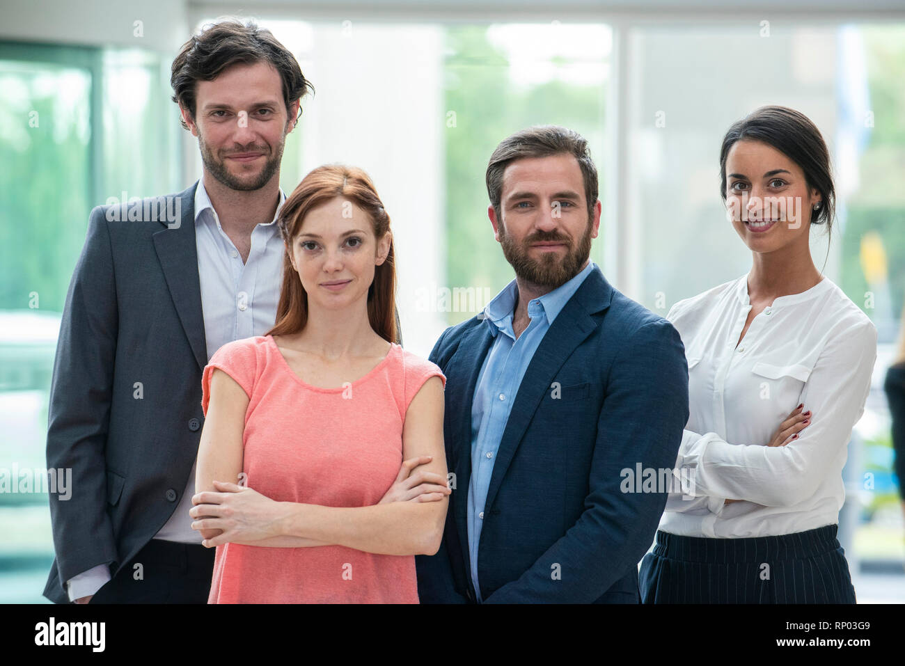 Smiling business people standing in hotel lobby Stock Photo - Alamy